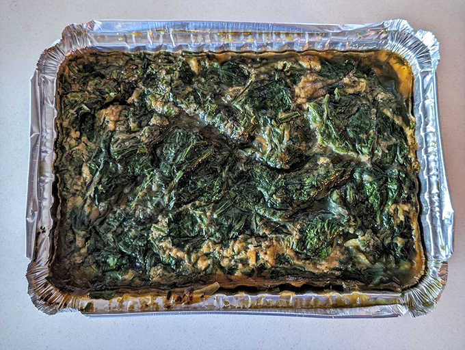 The egg bake emerges from the kitchen like a savory souffl&eacute;, with spinach nestled throughout and edges crisped to golden perfection.