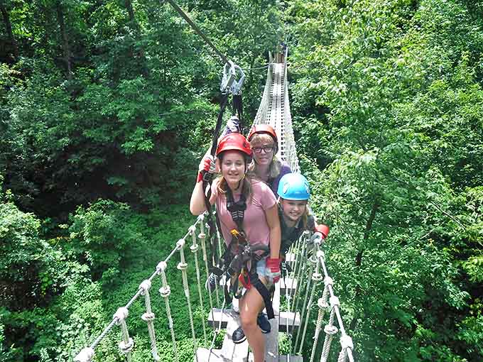 Three generations of thrill-seekers pause on the suspension bridge, proving adventure has no age limit.