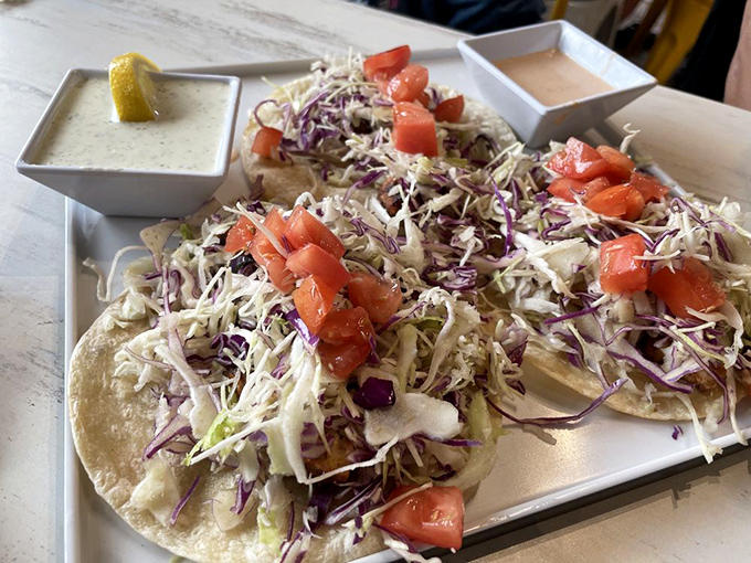 Florida fish tacos done right &ndash; locally-sourced fish nestled in soft tortillas with crisp veggies and a squeeze of lemon for that perfect zing.