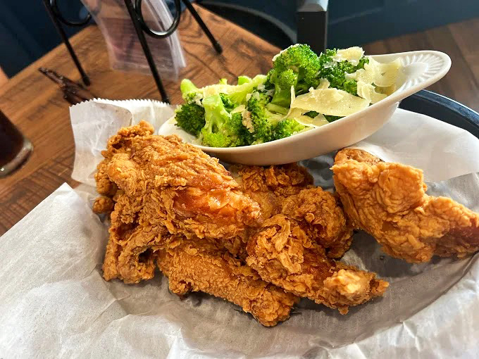 Perfectly fried chicken with a side of fresh broccoli &ndash; because even in comfort food paradise, balance matters.