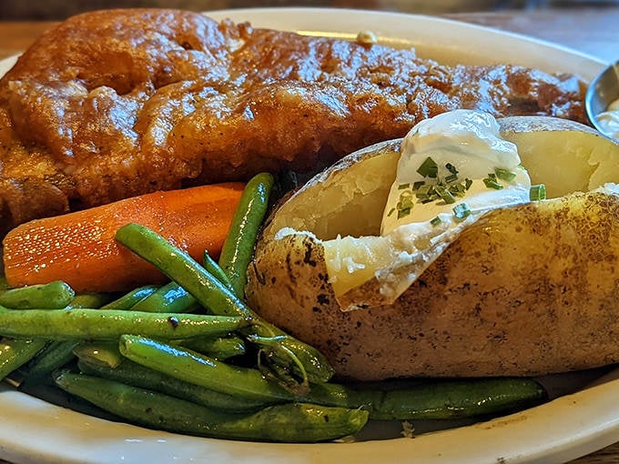 Golden-brown perfection on a plate. The walleye arrives with a crispy exterior hiding flaky, tender fish that practically melts on your fork.