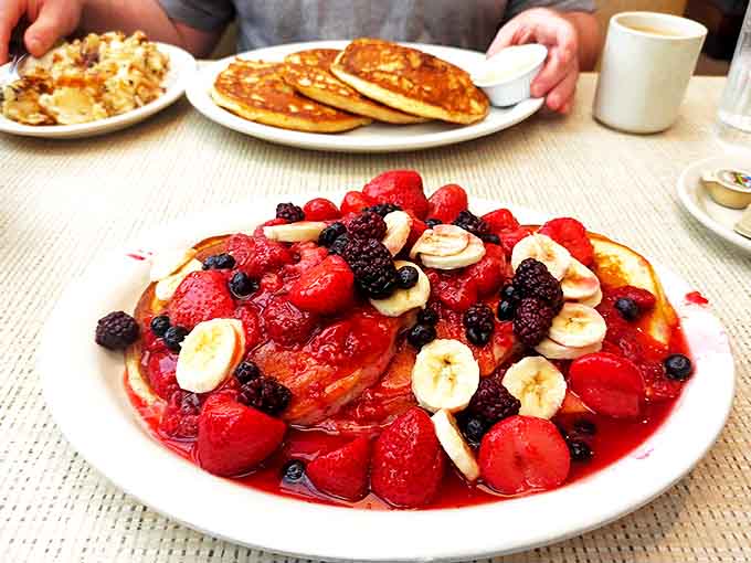 Fruit explosion indeed! This berry-banana mountain proves that sometimes breakfast should double as a work of art.