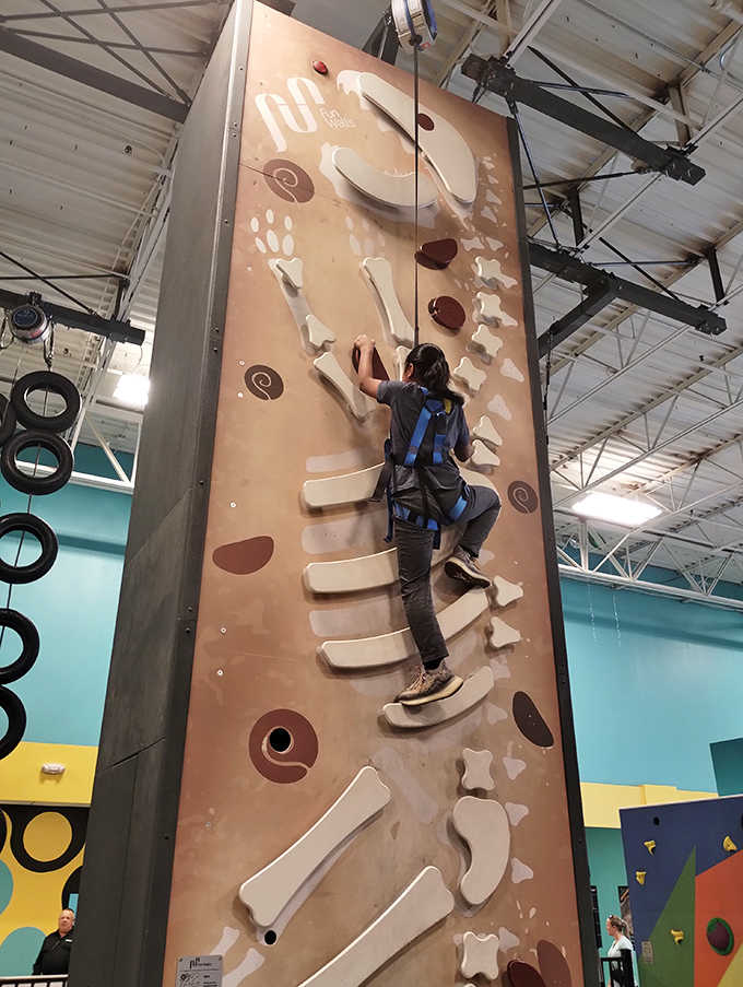 A determined climber tackles the innovative climbing wall, where finger strength meets problem-solving in a vertical puzzle that rewards persistence.