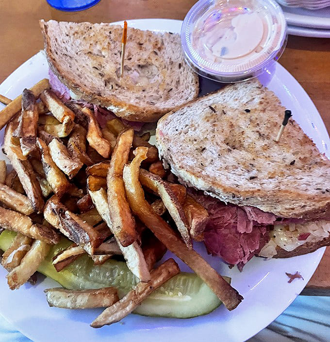 The legendary Reuben sandwich comes piled high with tender corned beef, tangy sauerkraut, and melted Swiss on grilled rye &ndash; sandwich perfection!