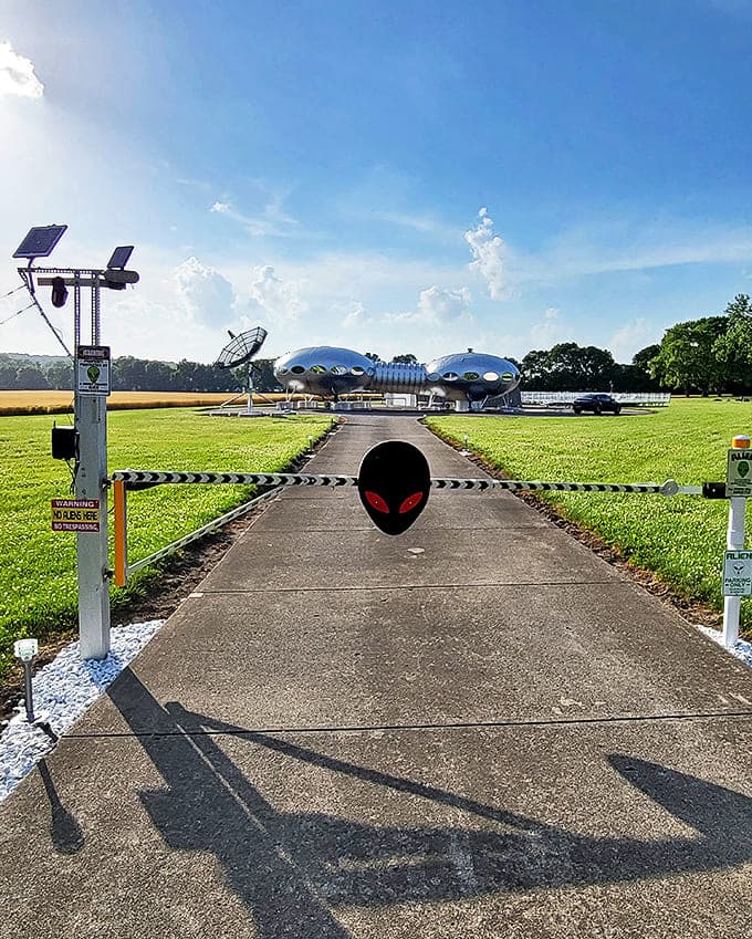 The entrance gate's alien guardian silently watches visitors approach, its red eyes a playful warning that you're leaving ordinary reality behind.