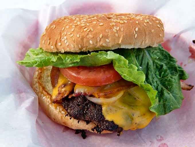 The burger arrives looking like it jumped straight out of a diner fantasy &ndash; juicy, cheese-draped, and ready to satisfy primal hunger pangs.