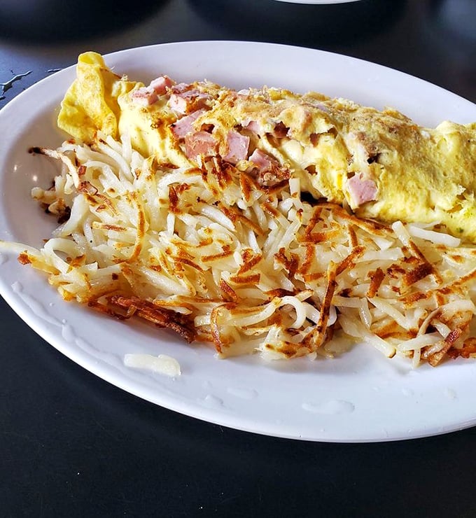 Ham and cheese omelet: Fluffy egg perfection with hash browns so crispy they practically play their own soundtrack.