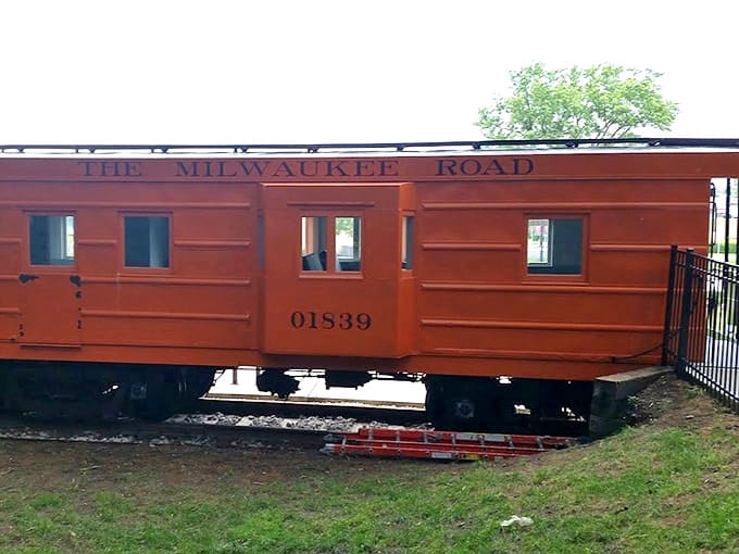 This preserved Milwaukee Road caboose offers a surprising history lesson between splashes – rust-colored nostalgia amid aquatic blues.