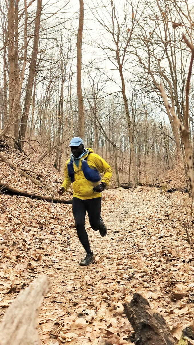A determined jogger tackles the leaf-covered path during the cooler months. These trails offer natural interval training with their rolling terrain.