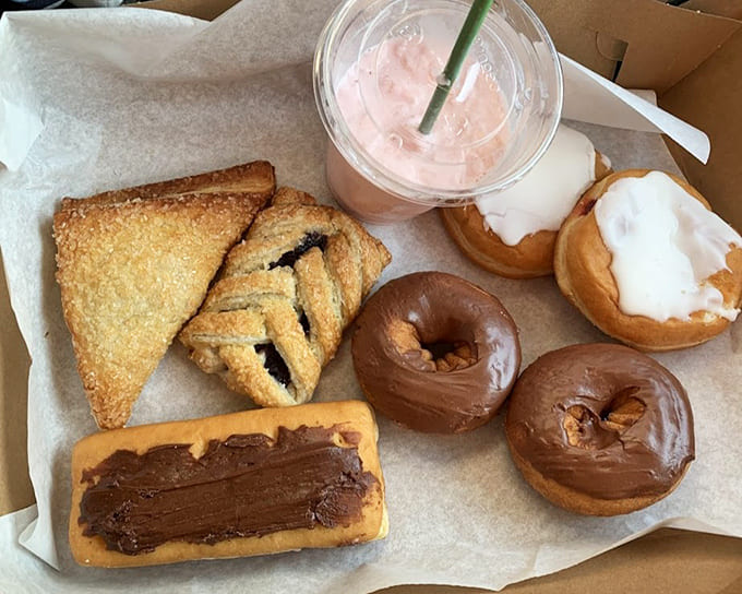 This assortment of donuts and pastries represents hours of pre-dawn baking, resulting in treats that taste like they were made just for you.