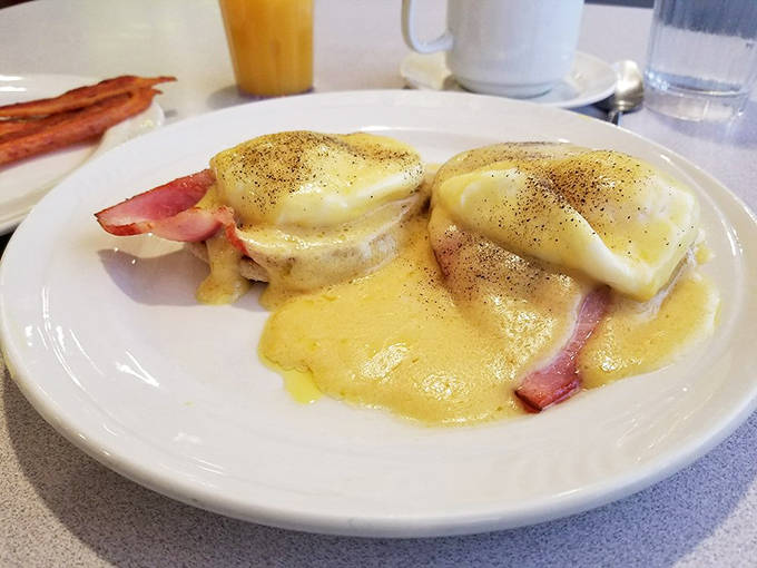 Eggs Benedict: where hollandaise cascades like yellow velvet over perfectly poached eggs. Breakfast doesn't get more indulgent than this.