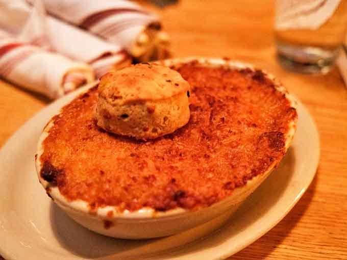 The Lobster Mac & Cheese arrives like a golden-crusted miracle, topped with a biscuit halo. Calories? Consider them sanctified.