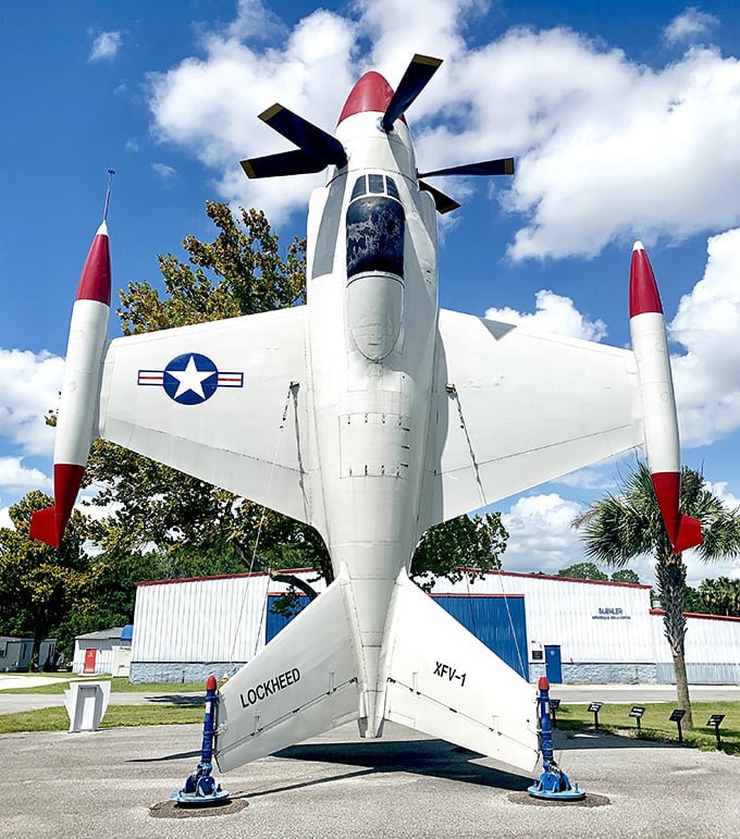 The Lockheed XFV-1 "Salmon" stands on its tail, defying gravity and common sense. This experimental vertical takeoff aircraft looks like something Wile E. Coyote would order from ACME.