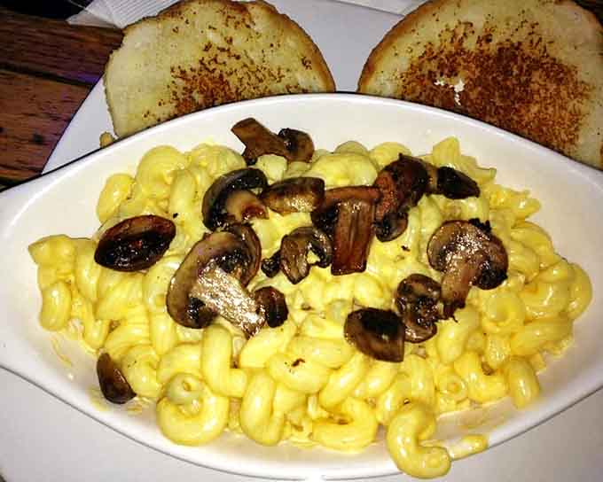 Mac and cheese topped with mushrooms, turning childhood comfort into grown-up satisfaction with every creamy bite.