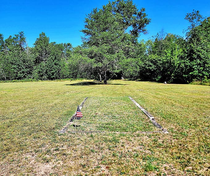 The rectangular outline of stone markers defines a family plot, a poignant reminder of generations lost to epidemics.