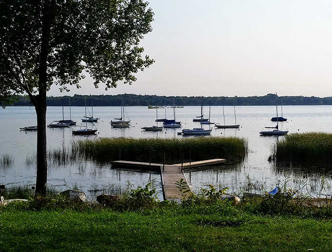 Sailboats dot the horizon at Matoska Park, where Minnesota's lake culture comes alive in picture-perfect form.