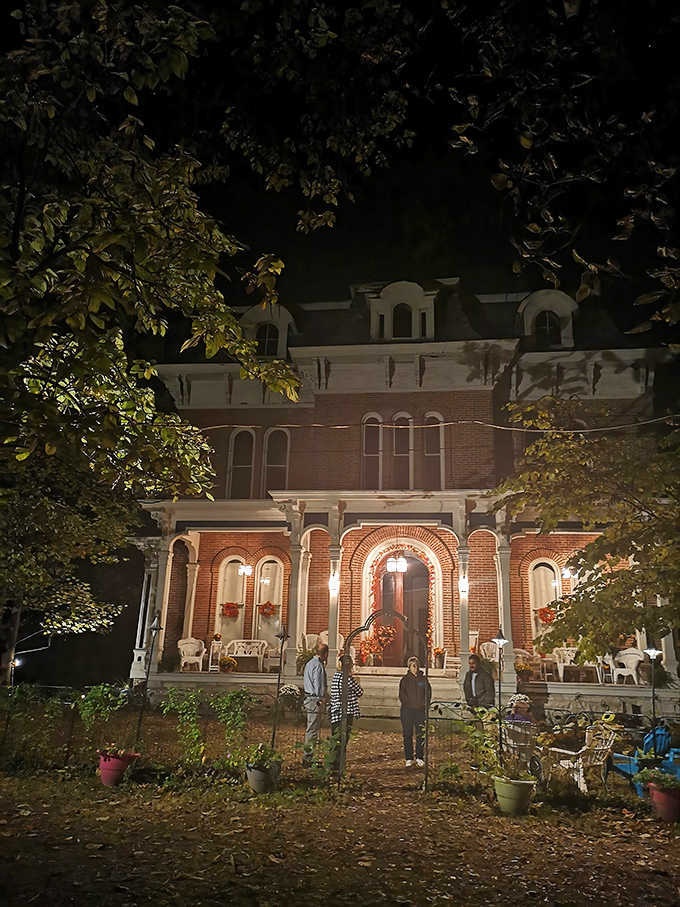 Night falls on the McPike Mansion as curious guests gather, their flashlight beams cutting through darkness that seems somehow thicker than normal.