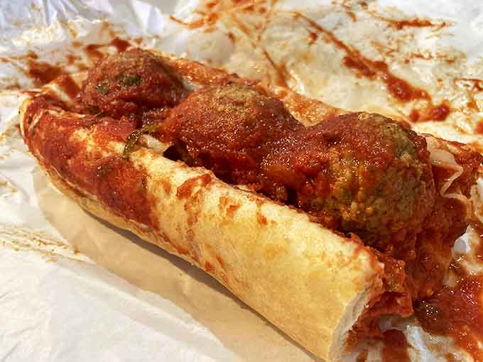 Meatballs nestled in fresh bread with sauce cascading down, this is comfort food that gives bear hugs to your soul.