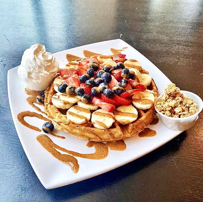 Fresh strawberries, bananas, and blueberries dance atop a golden stage, proving healthy ingredients can still feel indulgent.