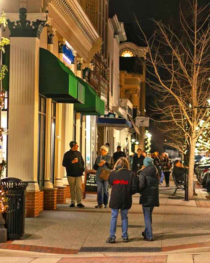 Evening strollers enjoy downtown's illuminated streets, where the nightlife is less about clubs and more about community.