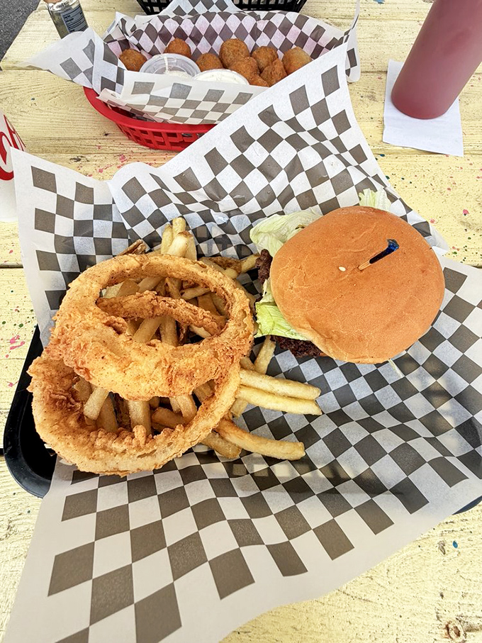 Behold the burger that launched a thousand return visits: pure beef, melted cheese, and enough golden fries to make you reconsider your afternoon plans.