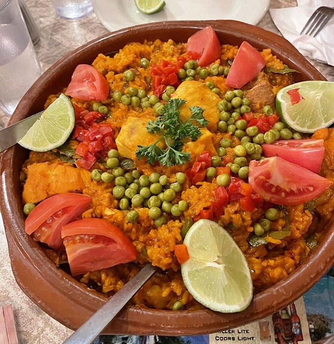 A colorful fiesta in a clay pot &ndash; where saffron rice meets seafood, chicken, and vegetables in perfect harmony.