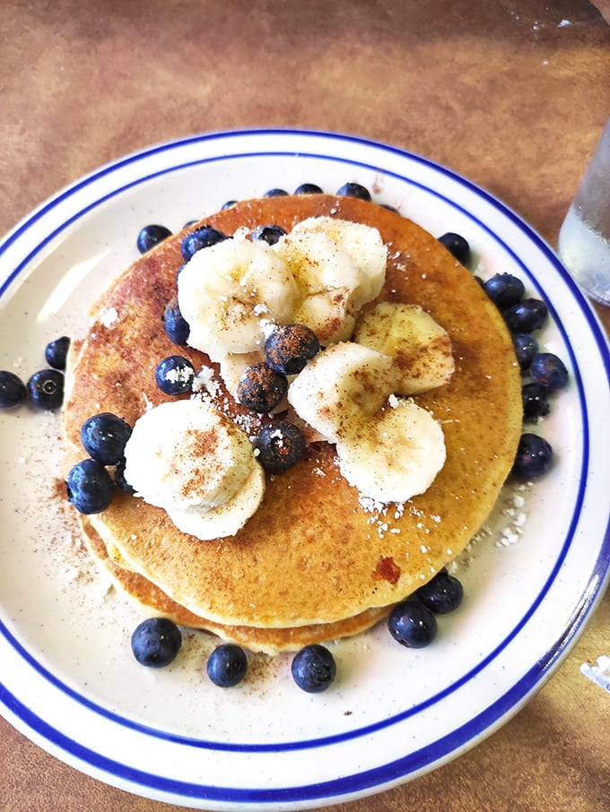 Golden-brown pancake perfection topped with fresh blueberries and bananas &ndash; the kind that makes you question why anyone needs fancy brunch.