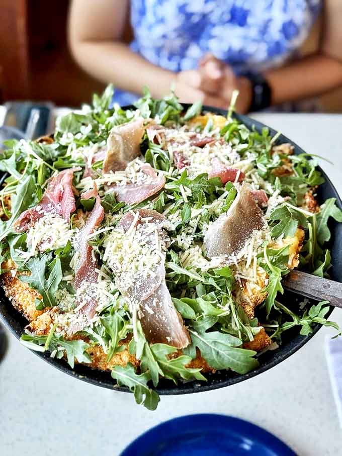Prosciutto and arugula dance atop a perfectly baked crust, creating a sophisticated flavor profile that would make Italian grandmothers nod in approval.