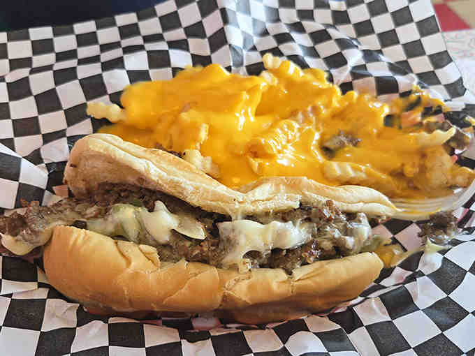 The Philly cheesesteak arrives as a beautiful mess of thinly-sliced beef, melted cheese, and grilled onions on a soft roll – requiring multiple napkins and zero regrets.