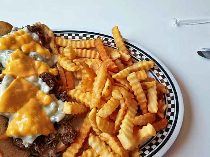 Philly Steak combo: Melted cheese cascades over thinly-sliced beef like a yellow waterfall of deliciousness &ndash; fork required, no regrets allowed.