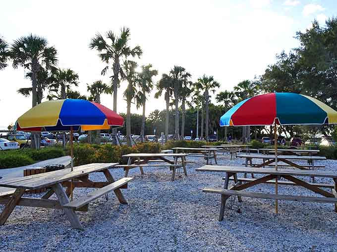 Rainbow umbrellas dot the landscape like tropical mushrooms, offering shade and splashes of joy near beach access.