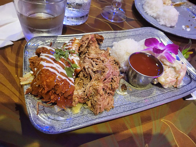 A plate that tells two delicious stories: slow-roasted kalua pork alongside coconut chicken, with macaroni salad playing the perfect supporting role.