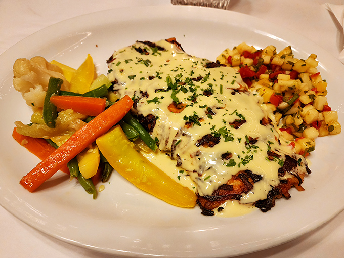 The Potato-Crusted Salmon arrives like a work of art, surrounded by colorful vegetables and topped with a sauce worth writing home about.
