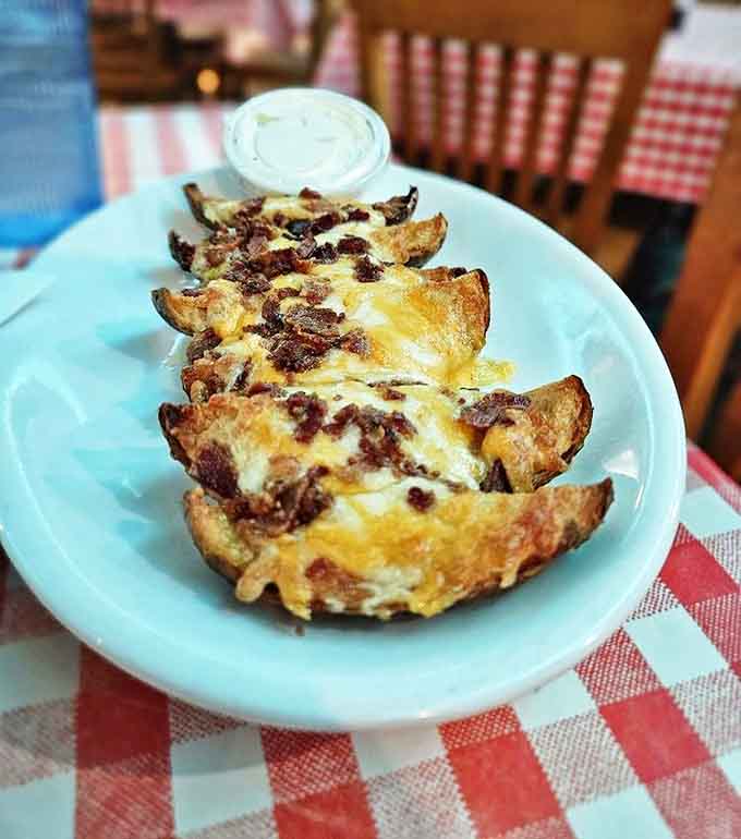 Loaded potato skins arrive bubbling with melted cheese and bacon bits, a shareable starter that rarely makes it around the table twice.