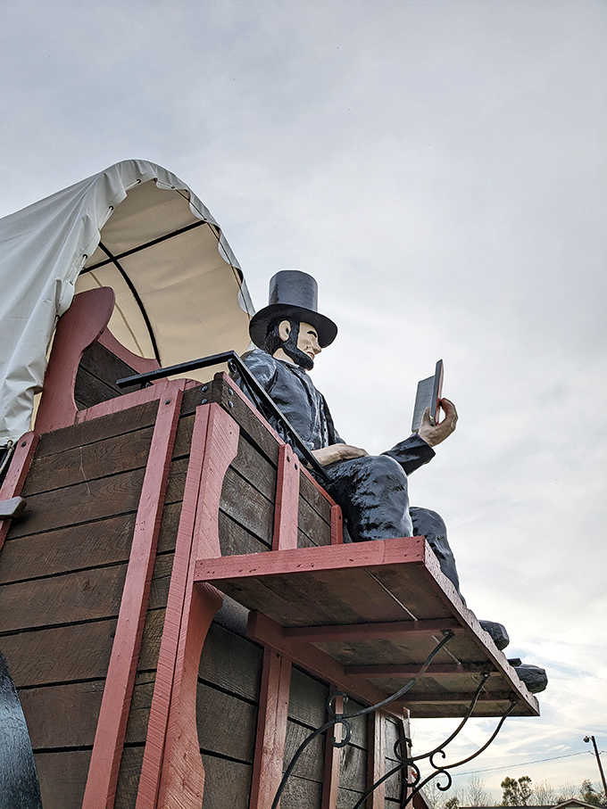 Young Lincoln sits eternally reading, a tribute to his early career as a circuit-riding lawyer before presidential duties called.