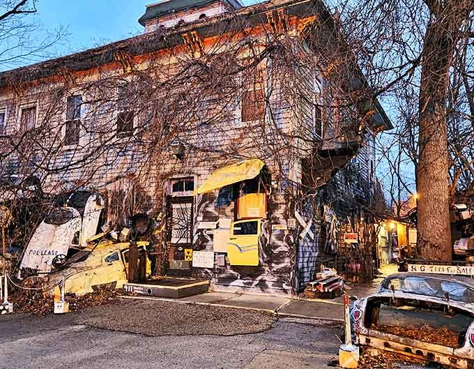 The weathered Victorian structure looms against the twilight sky, ivy climbing its walls like nature reclaiming a forgotten dream.
