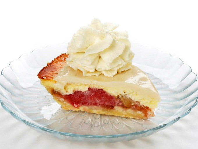 The Rhubarb Delight elevates the classic with a silky custard layer that transforms this humble vegetable into something that feels like edible sunshine.