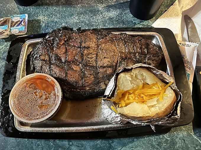 That baked potato looks positively dainty next to its meaty companion, like a sidekick who knows exactly who the star of this show is.