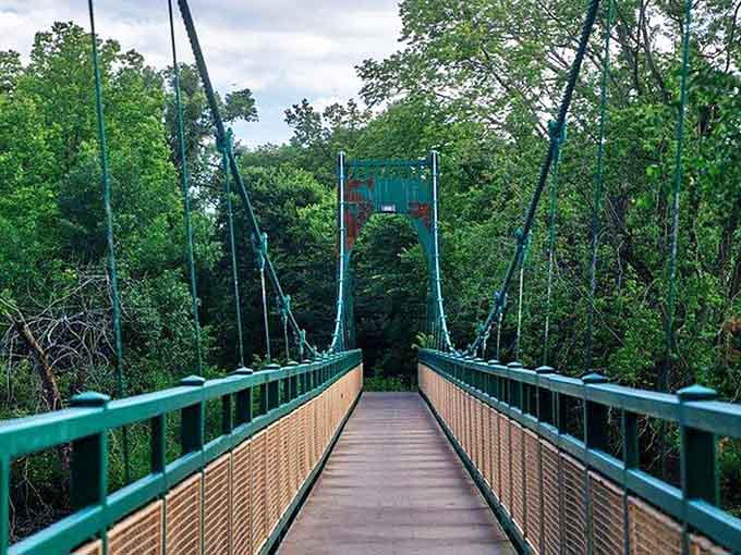 The Swing Bridge invites adventurers to cross over to new discoveries, its green framework a perfect complement to the surrounding foliage.