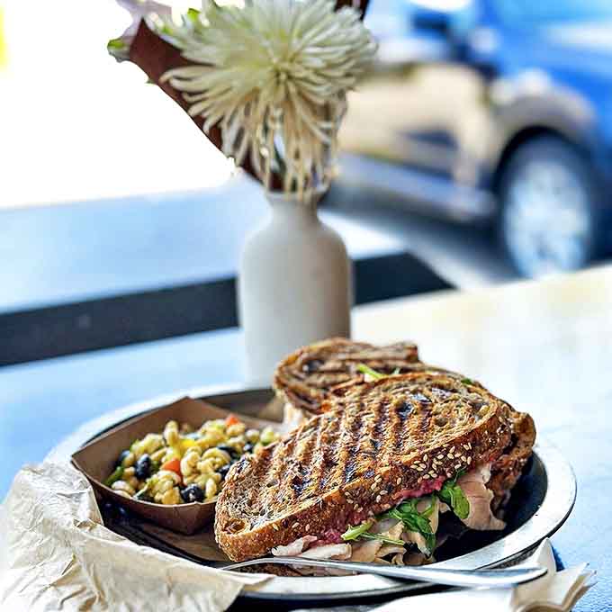 That's not just a sandwich, that's architectural genius between two slices of sourdough with enough filling to make you forget your own name.