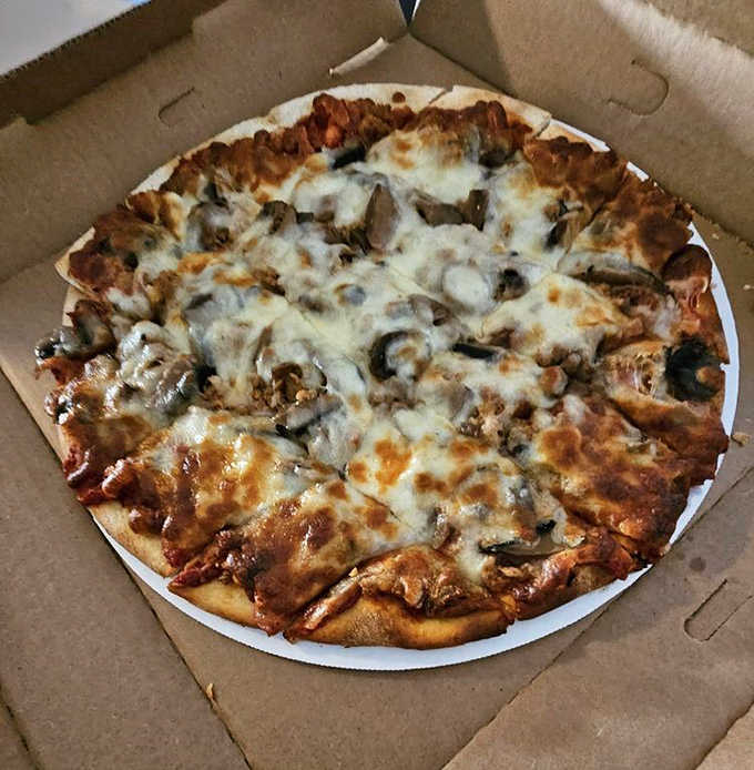 This isn't just pizza &ndash; it's a circular canvas where sausage and mushrooms perform a savory duet atop a bed of melted cheese and tangy sauce.