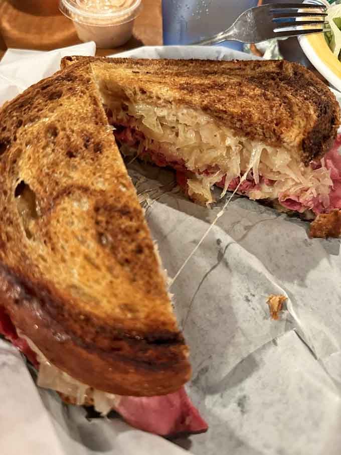 Corned beef, sauerkraut, and melted cheese meet perfectly toasted rye in this classic Reuben that would make any deli proud.