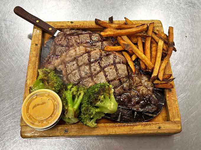The steak arrives sizzling on a wooden board &ndash; perfectly grilled, beautifully marked, and ready to satisfy that primal hunger after a day exploring Michigan's wilderness.