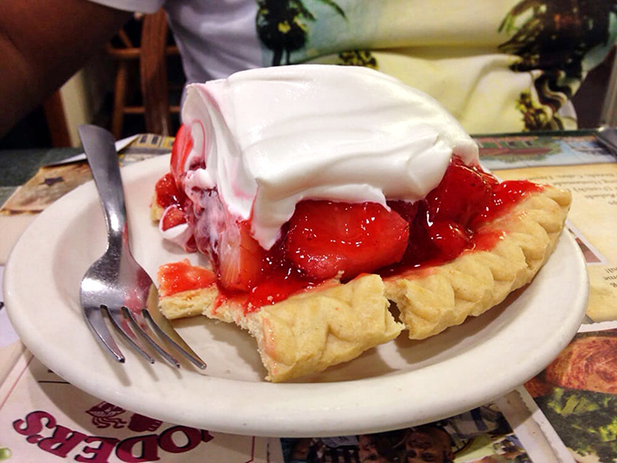 This strawberry pie isn't just dessert &ndash; it's a religious experience. Fresh berries glisten beneath a cloud of whipped cream in a perfect buttery crust.