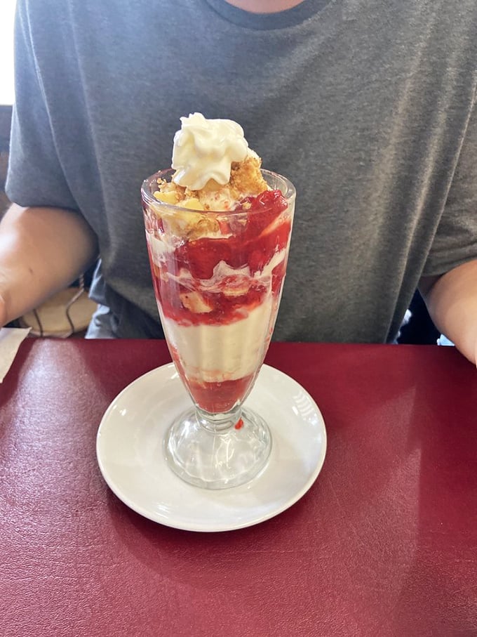 Layers of sweet nostalgia in a glass&mdash;strawberry sauce cascading over vanilla ice cream with that essential dollop of whipped cream.