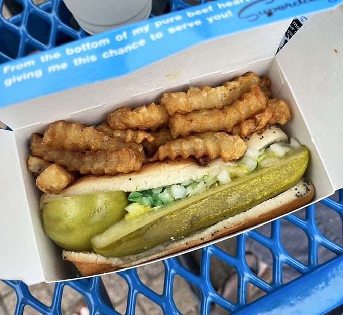 The signature creation lounges contentedly in its blue box, surrounded by golden crinkle-cut fries like a king on his throne.