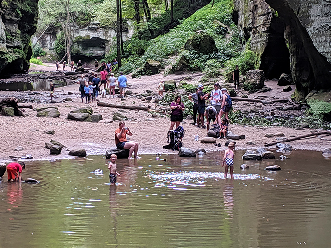 Children splash in nature's playground, where smooth stones and shallow waters create the perfect summer cooling station.