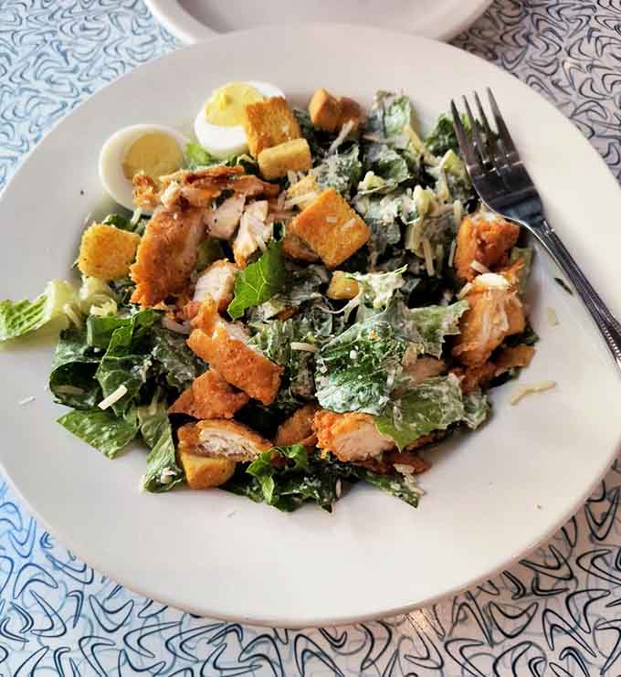 Caesar salad done right with crispy chicken, because sometimes you need greens before the sweet stuff arrives.