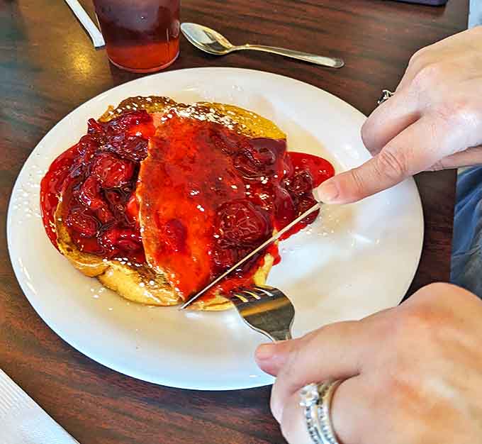 Strawberry-topped French toast dusted with powdered sugar creates a sweet masterpiece that photographs beautifully but tastes even better than it looks.