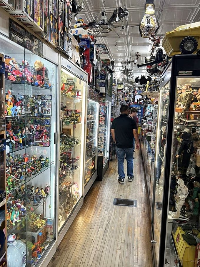 These narrow passages between shelves are basically time tunnels, each one leading to a different decade of your youth.